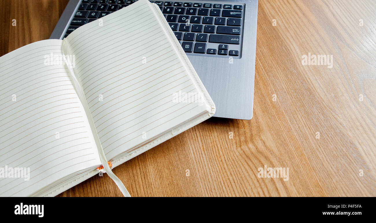 Notepad, laptop on old wooden desk. View from above with copy space in ...
