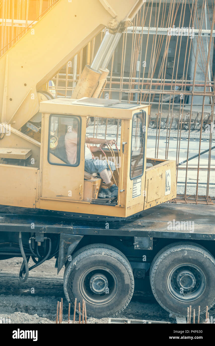 Mobil crane lifting cabin, controlling a machine that holds thousand ...