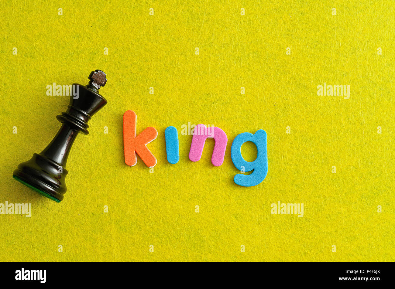 A king chess piece with the word king on a yellow background Stock ...
