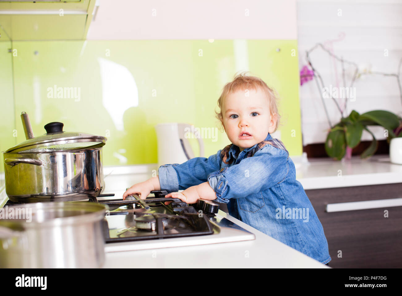 Cute boy plays with the gas stove Stock Photo - Alamy