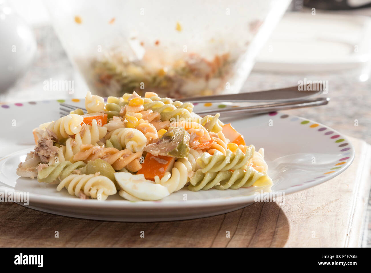 colorful curly macaroni salad with tomato, surimi, egg, corn and tuna ...