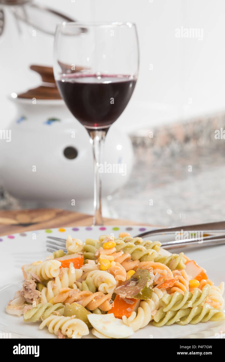 colorful curly macaroni salad with tomato, surimi, egg, corn and tuna ...