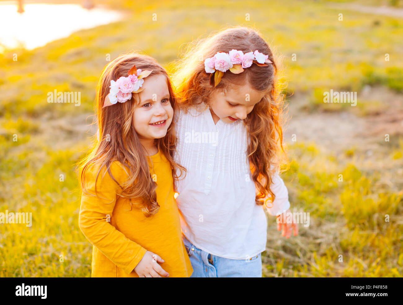 two sisters kids on sunset outdoor Stock Photo - Alamy