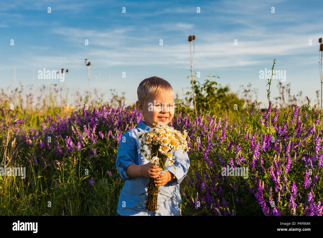 Cute boy with flowers Stock Photo - Alamy