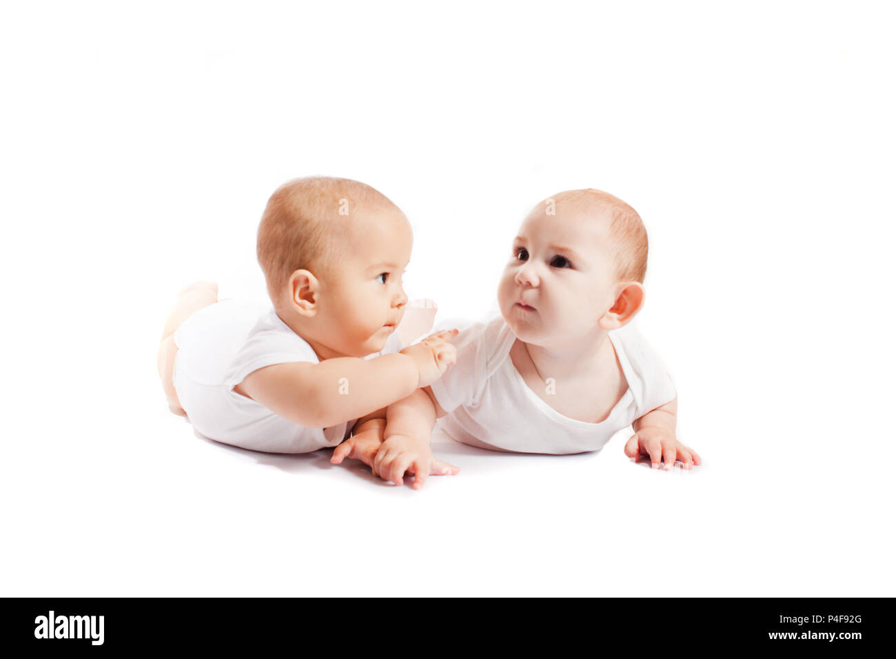 Two babies lying Stock Photo - Alamy