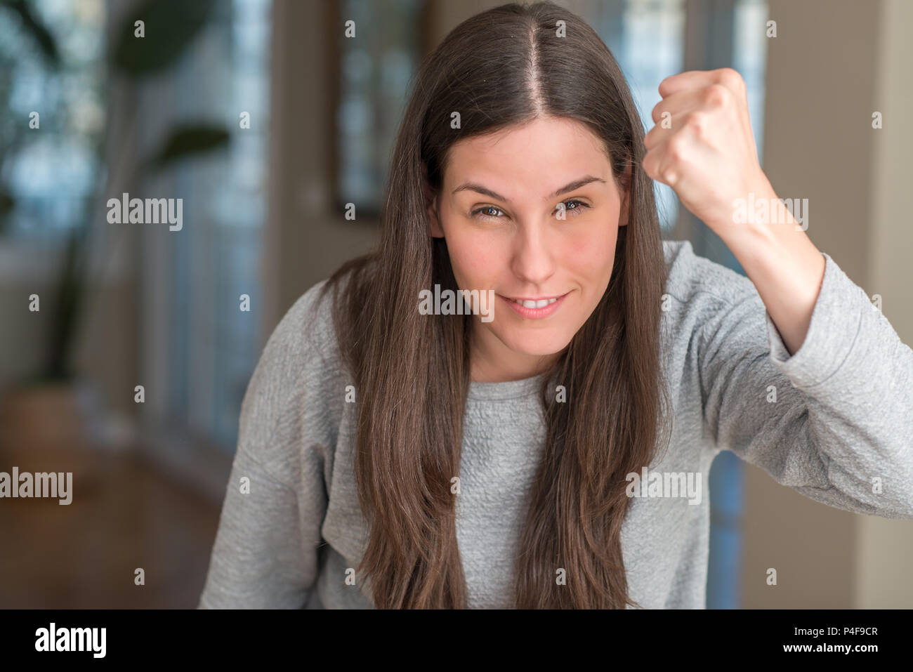 Angry young woman raising hand hi-res stock photography and images - Alamy