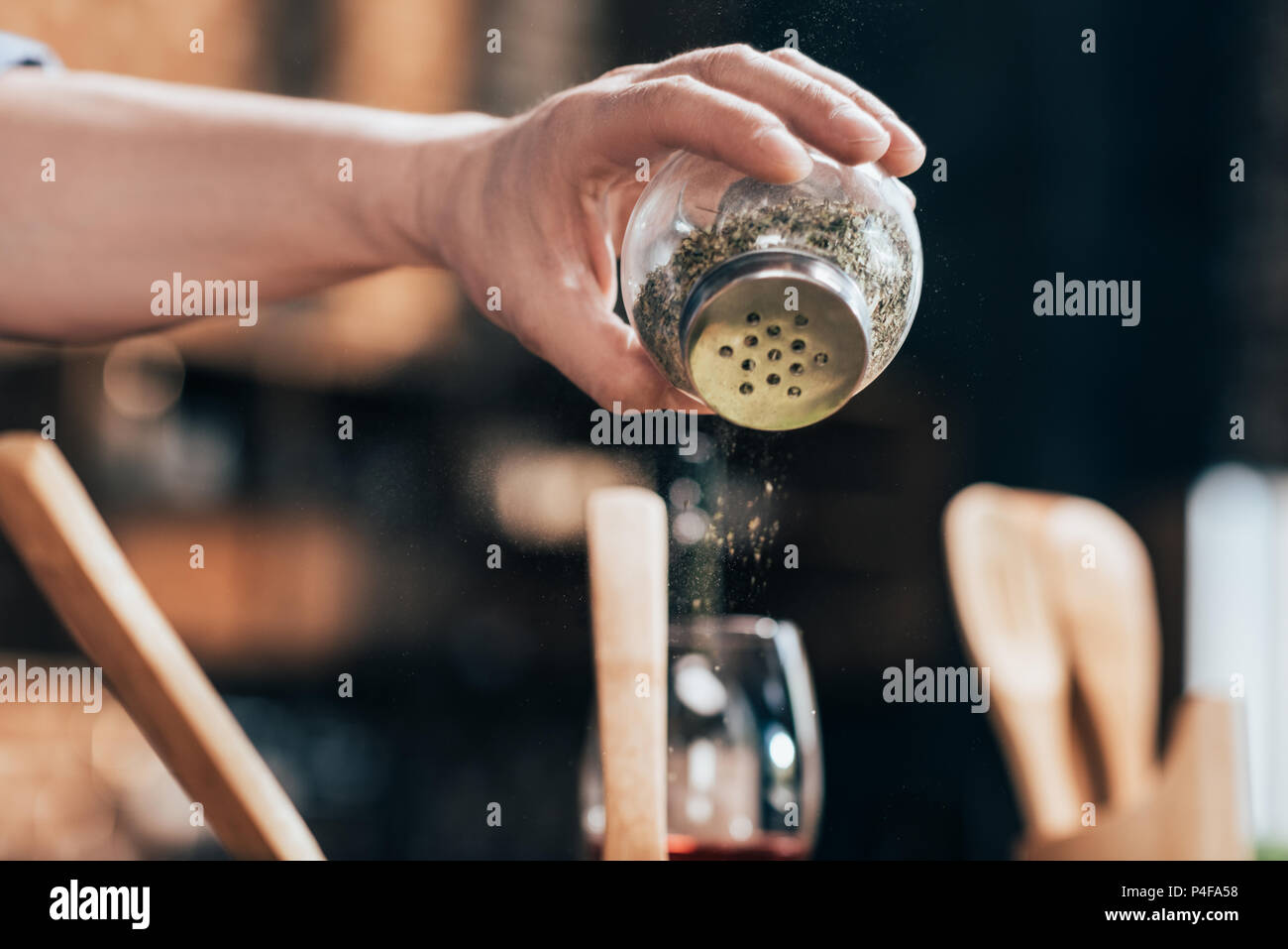 close-up partial view of person adding spices while cooking salad Stock ...