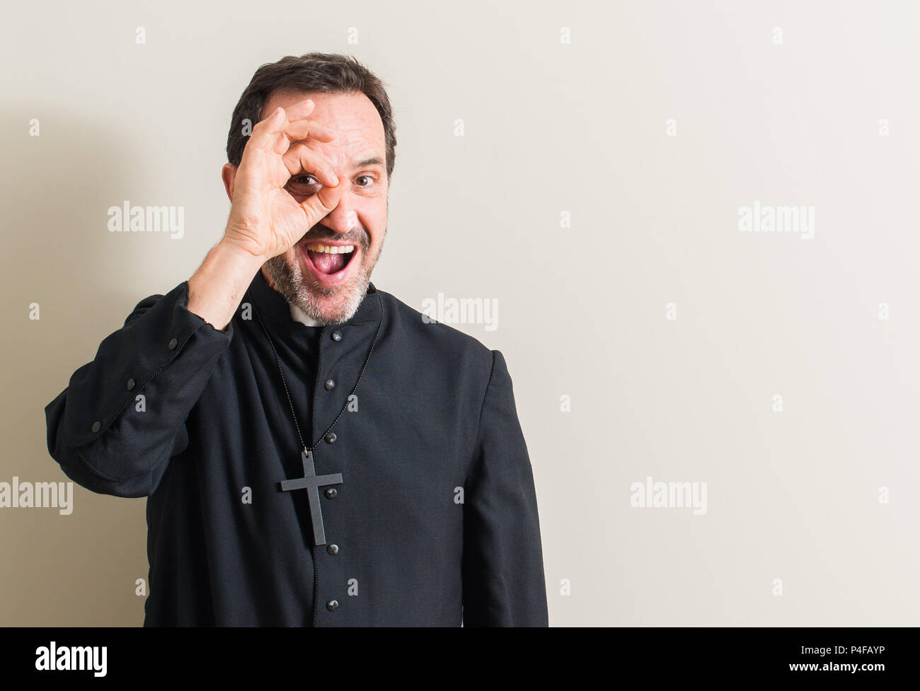 Senior priest religion man with happy face smiling doing ok sign with ...