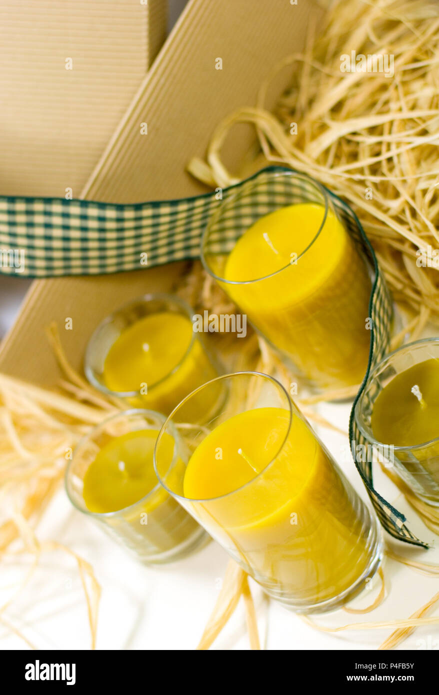 five yellow candles, ribbon and box Stock Photo - Alamy