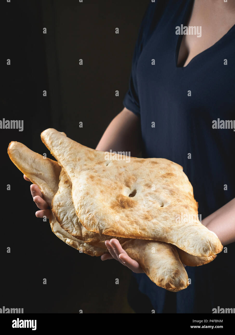 partial view of person holding tasty traditional georgian flatbreads ...