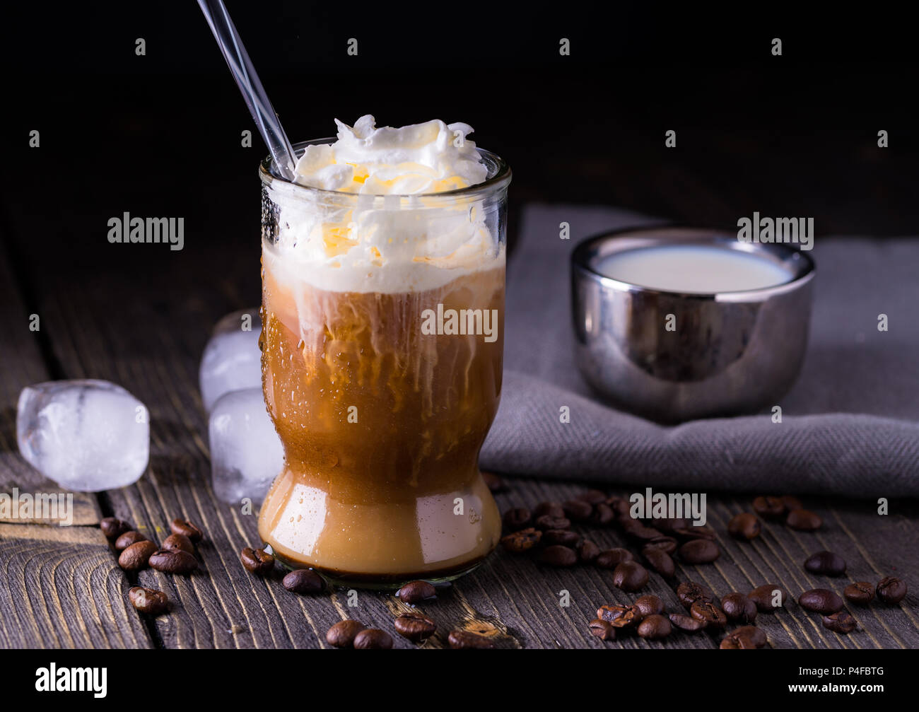 Ice coffee in a small glass on dark natural desk Stock Photo - Alamy