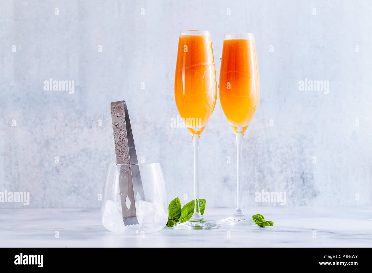 summer alcoholic fruit drink in glasses for champagne. on the marble ...