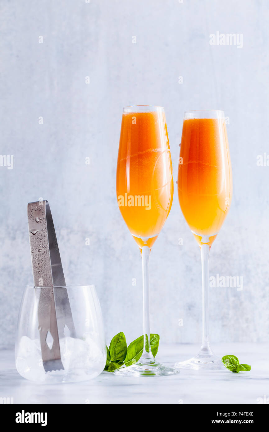 summer alcoholic fruit drink in glasses for champagne. on the marble ...