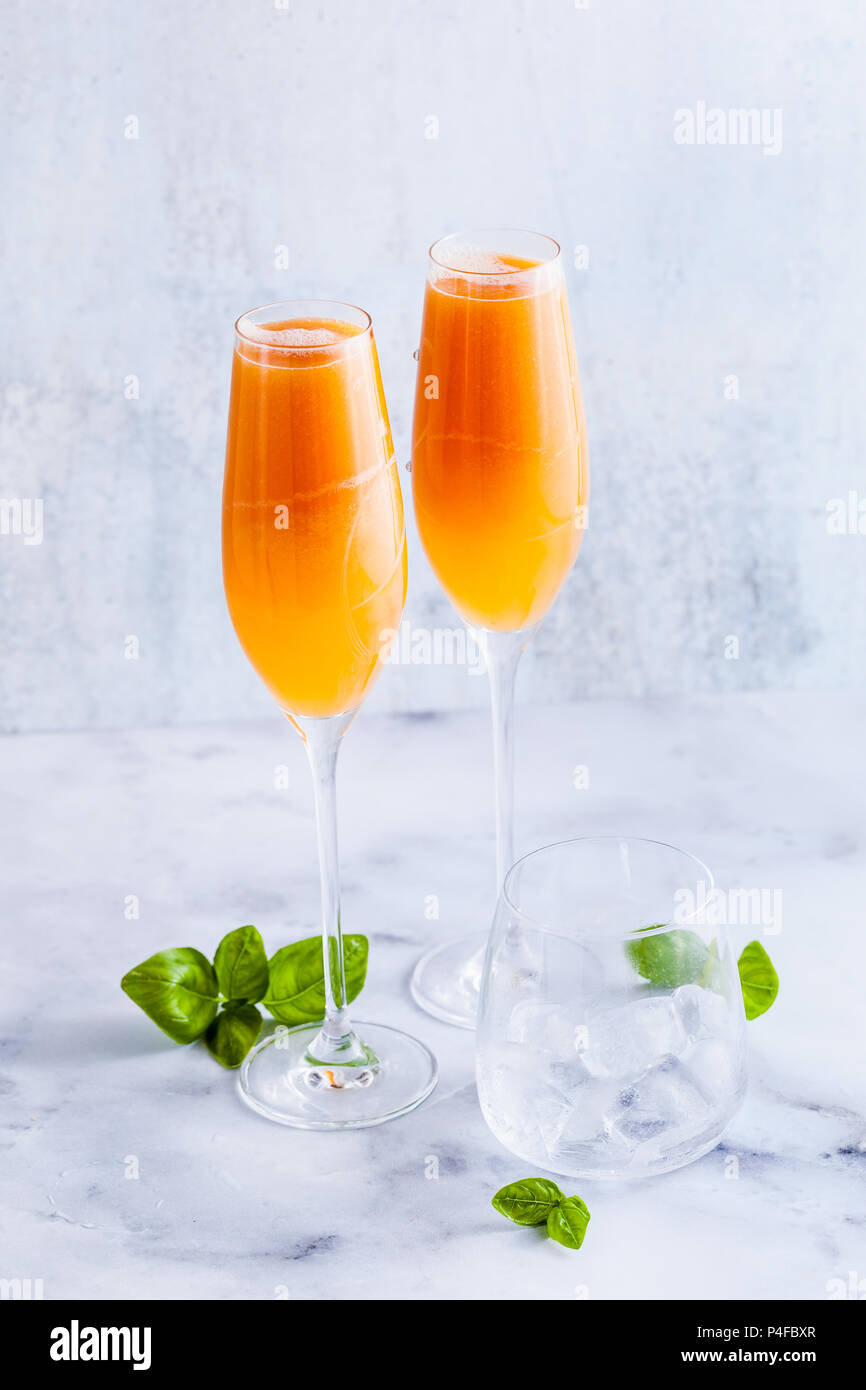 summer alcoholic fruit drink in glasses for champagne. on the marble ...