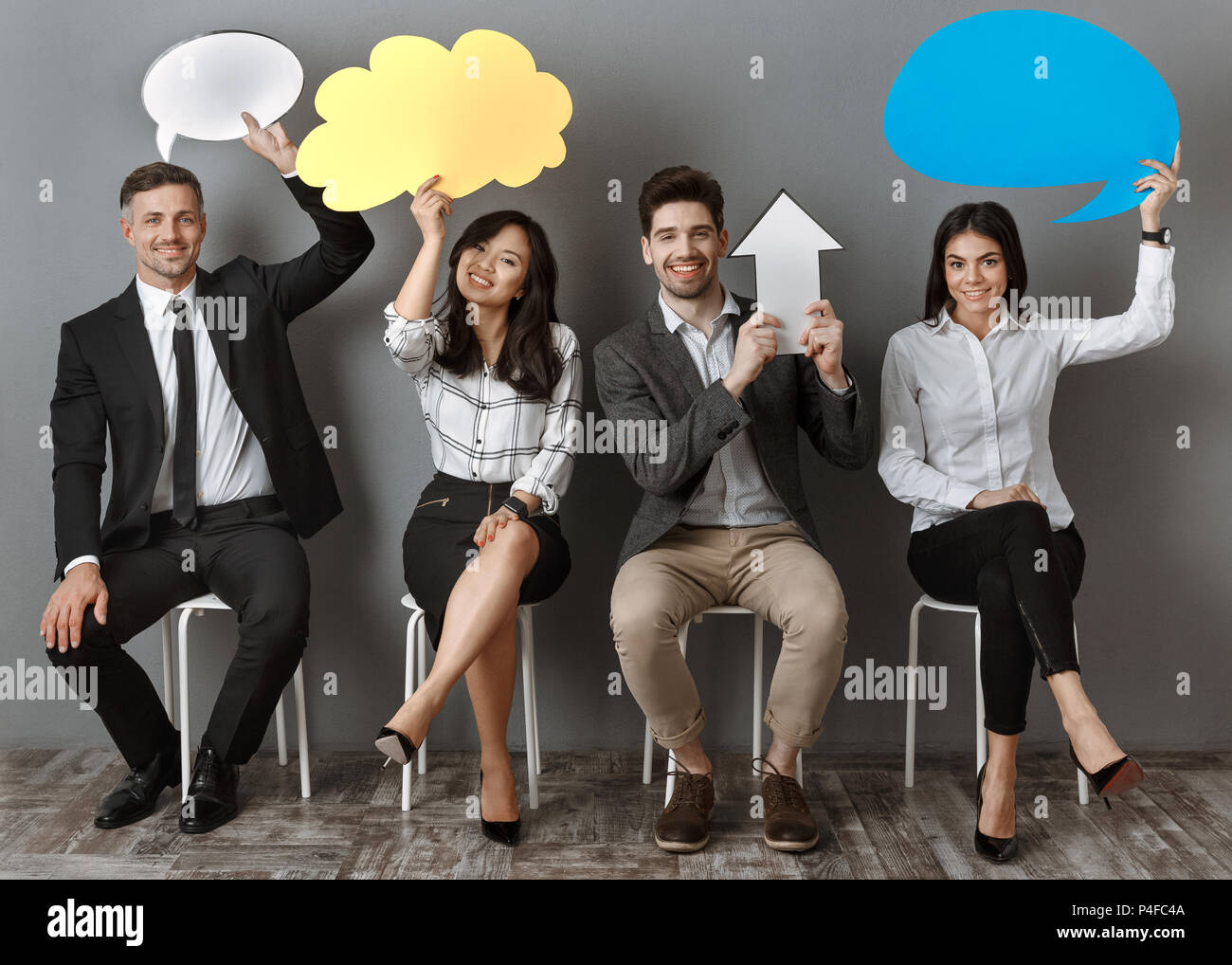 smiling multiethnic business people with paper chat bubbles and arrow ...