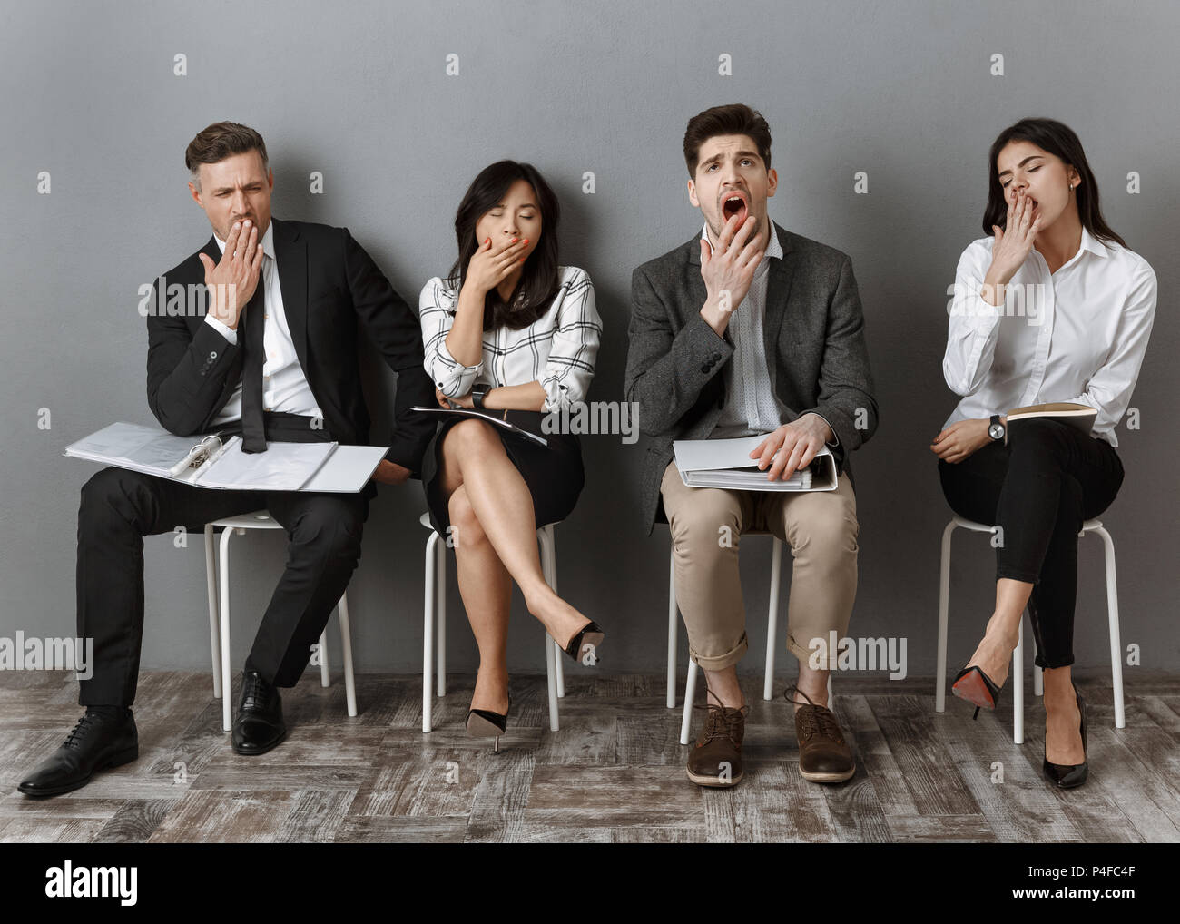 tired multicultural business people with folders and notebooks waiting ...