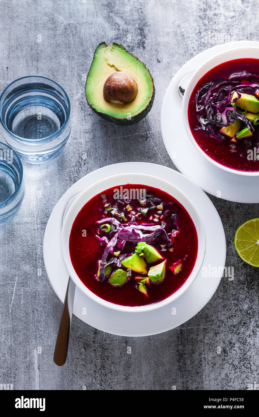 raw raw soup of fresh red vegetables and avocado in a plate on the ...