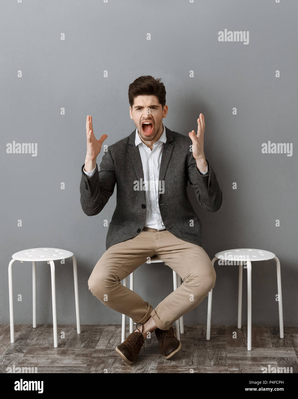 frustrated businessman in suit gesturing while waiting for job ...