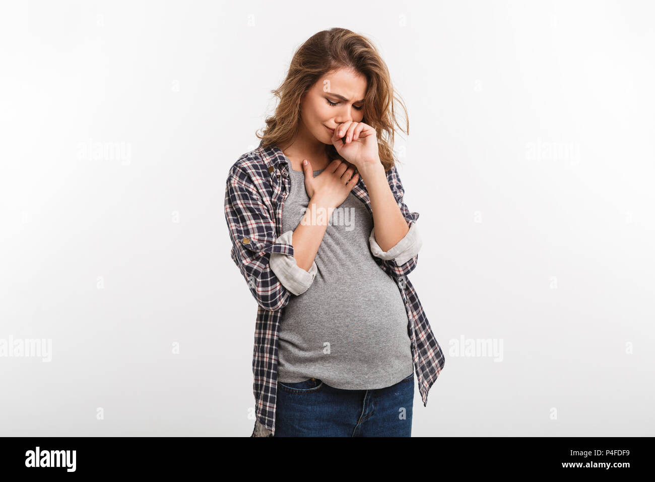 portrait of young pregnant woman crying isolated on grey Stock Photo ...