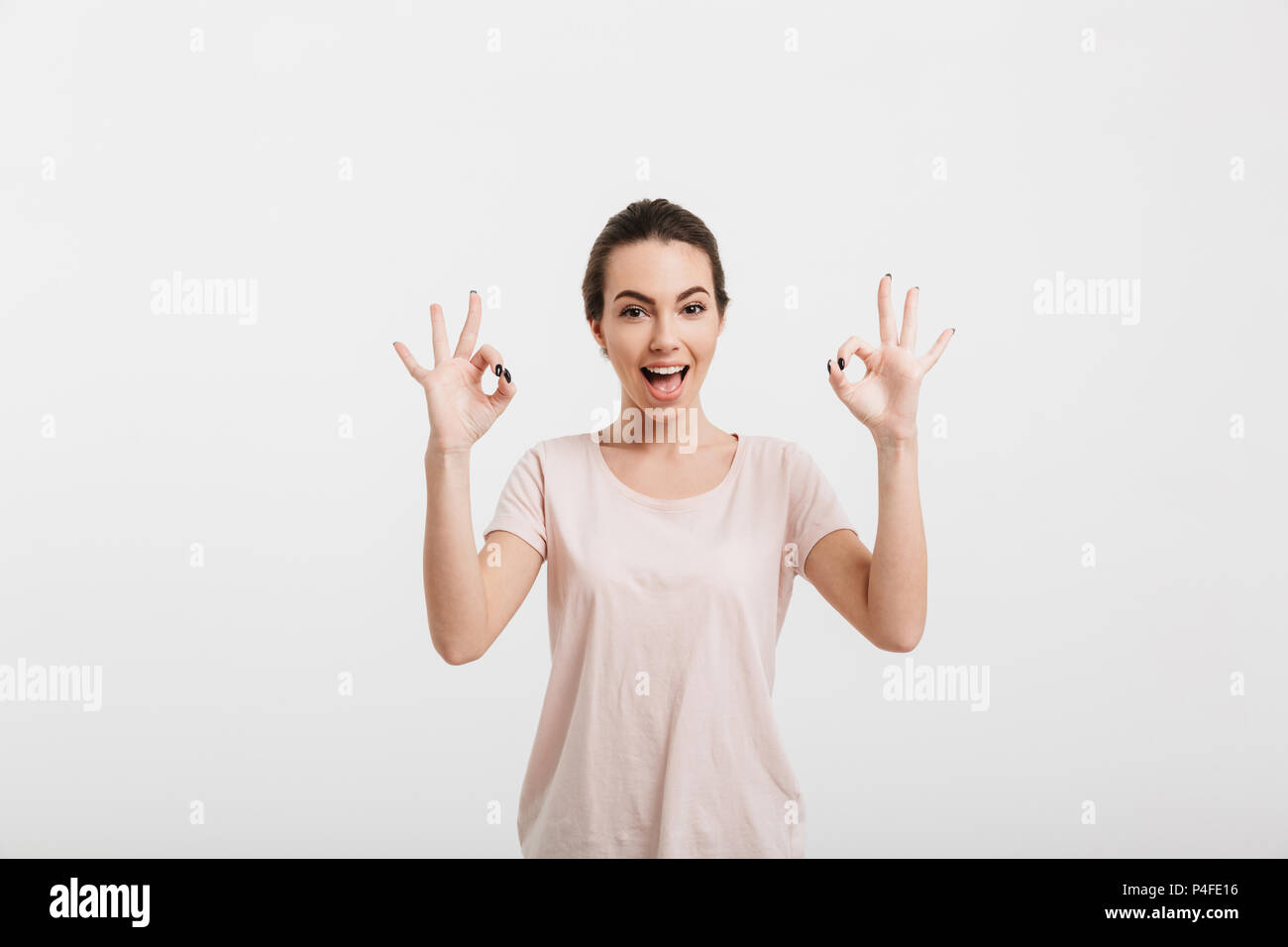 Cheerful girl showing ok hands hi-res stock photography and images - Alamy