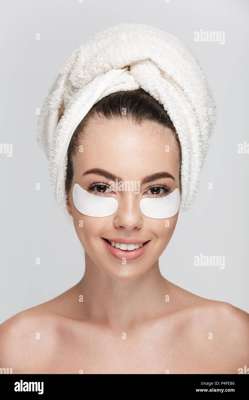 beautiful young woman with cosmetic patches isolated on white Stock ...