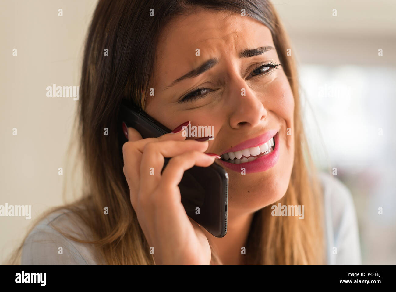 Sad woman talking on the smartphone, depressed and crying. Breaking off ...