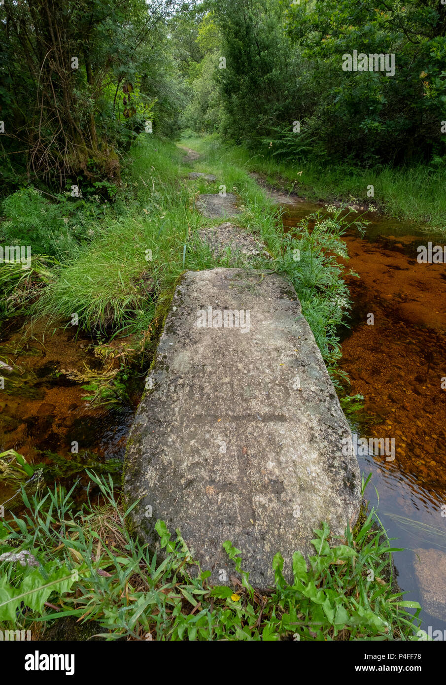 Footbridge made from an old gravestone which crosses over a small ...
