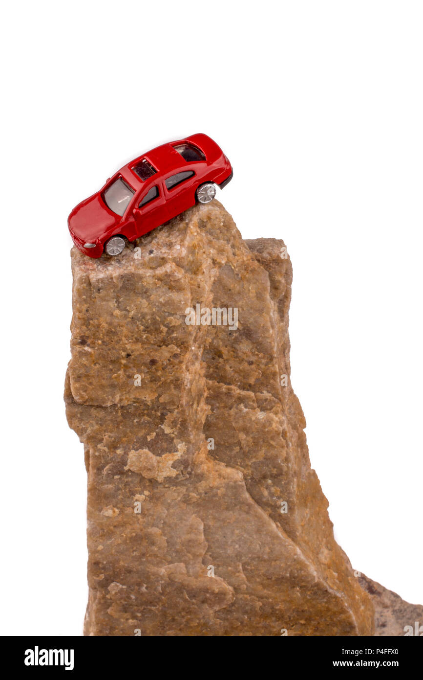 Little red model car on the top of a rock Stock Photo - Alamy