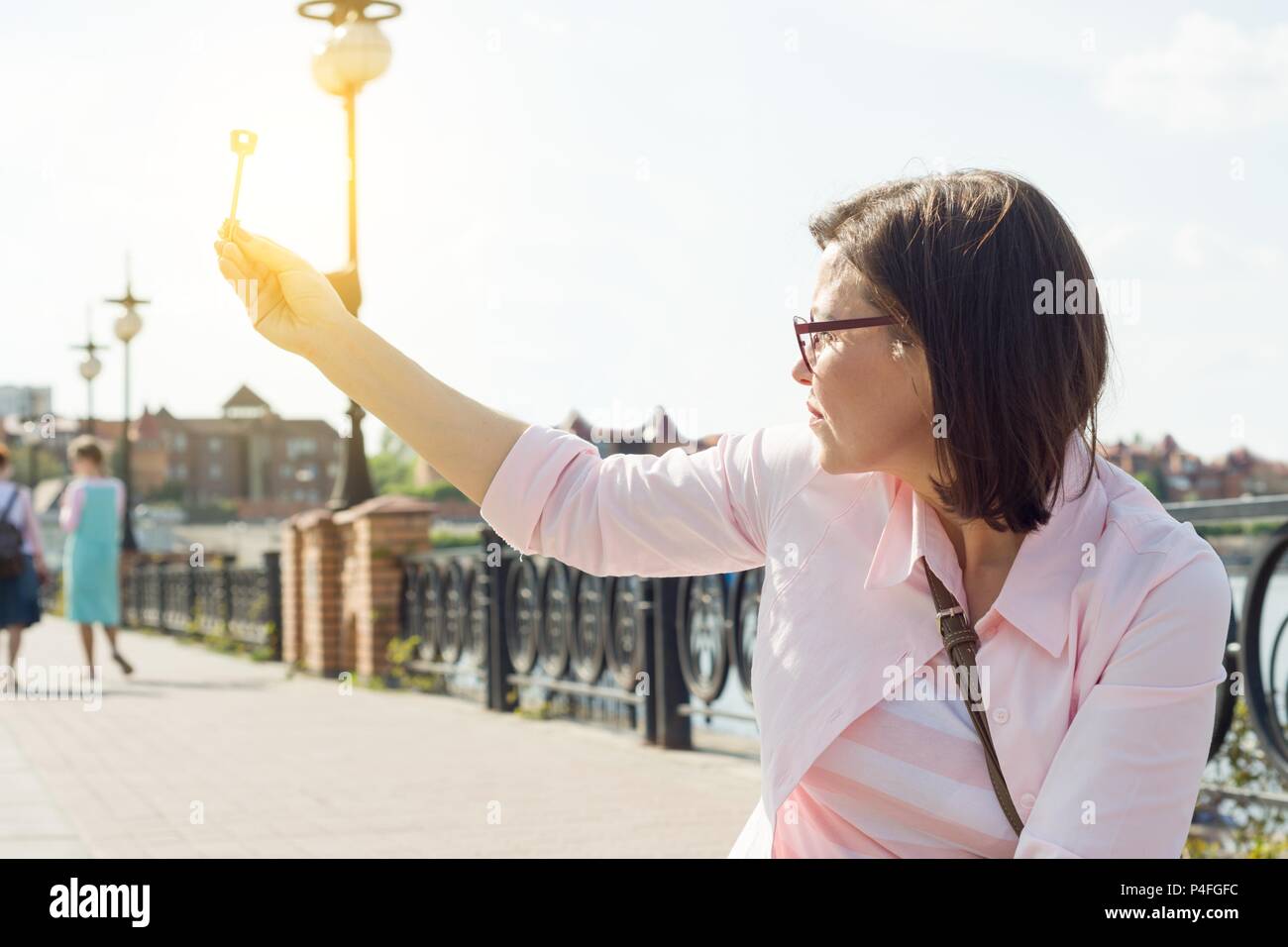 Mature woman showing keys hi-res stock photography and images - Alamy