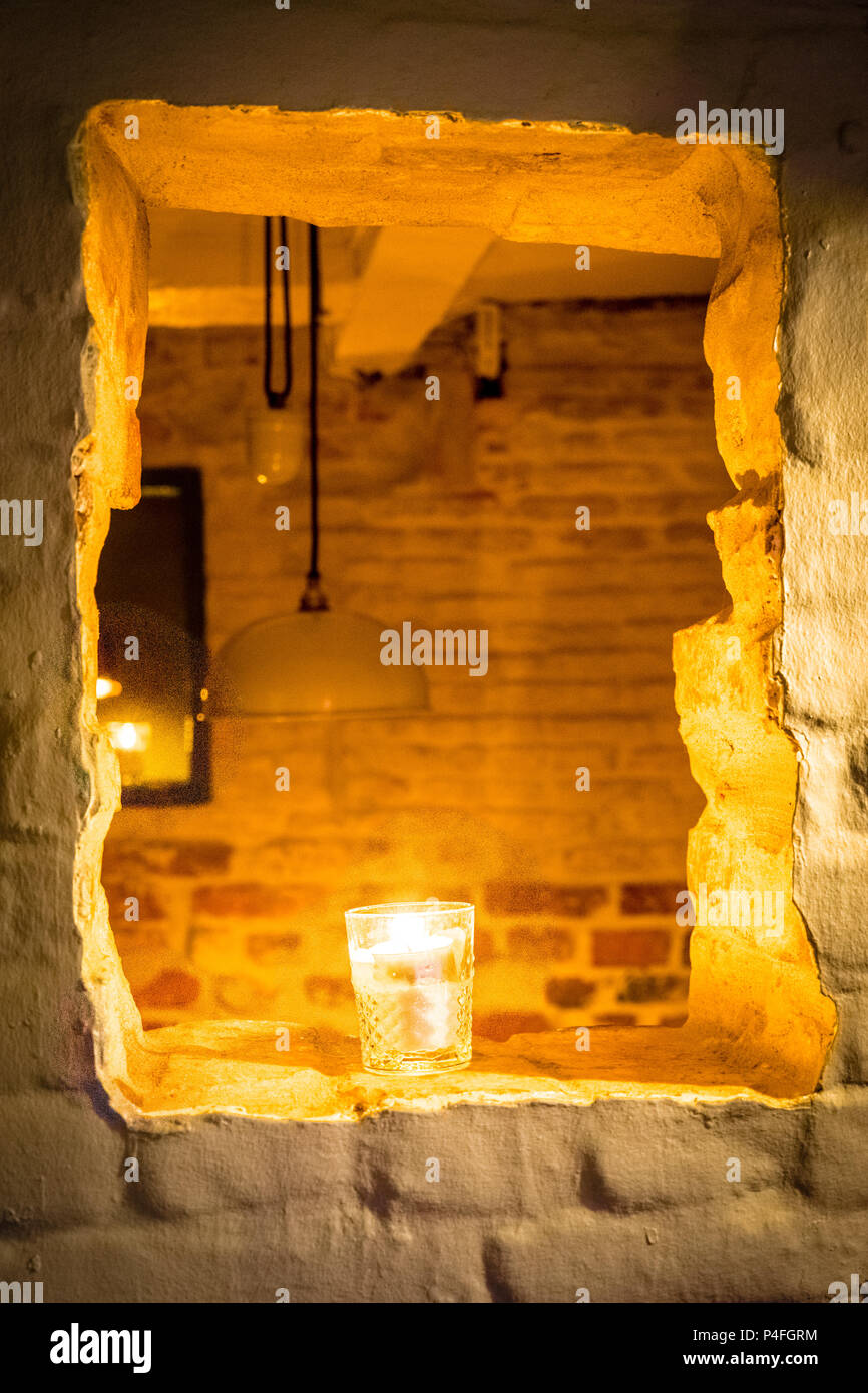 Candle light in wall opening Stock Photo - Alamy