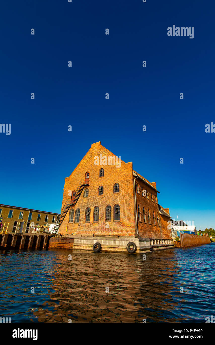 View at traditional red brick building by the canal in Copenhagen ...