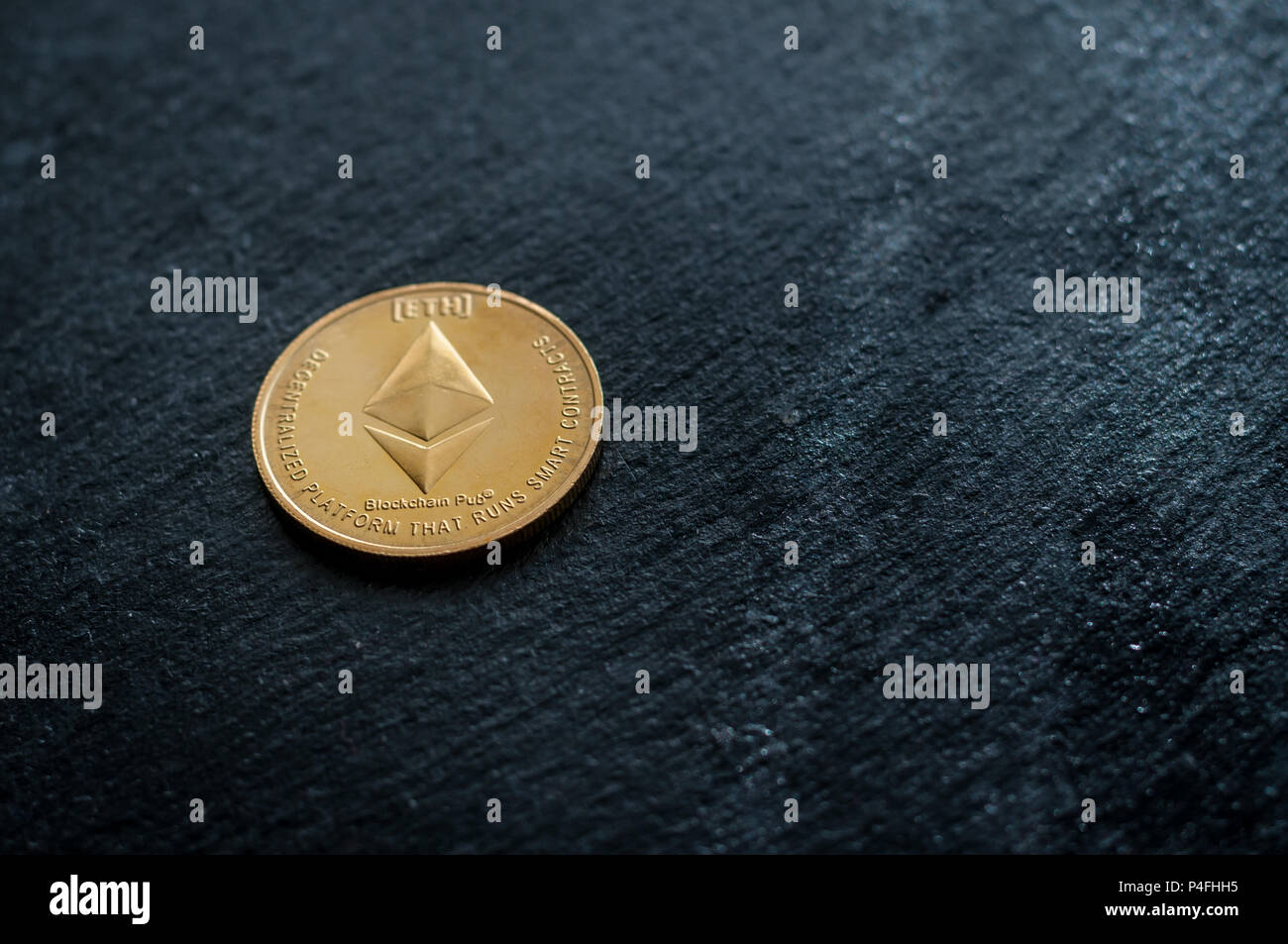 the Etherium gold coin on black background Stock Photo - Alamy