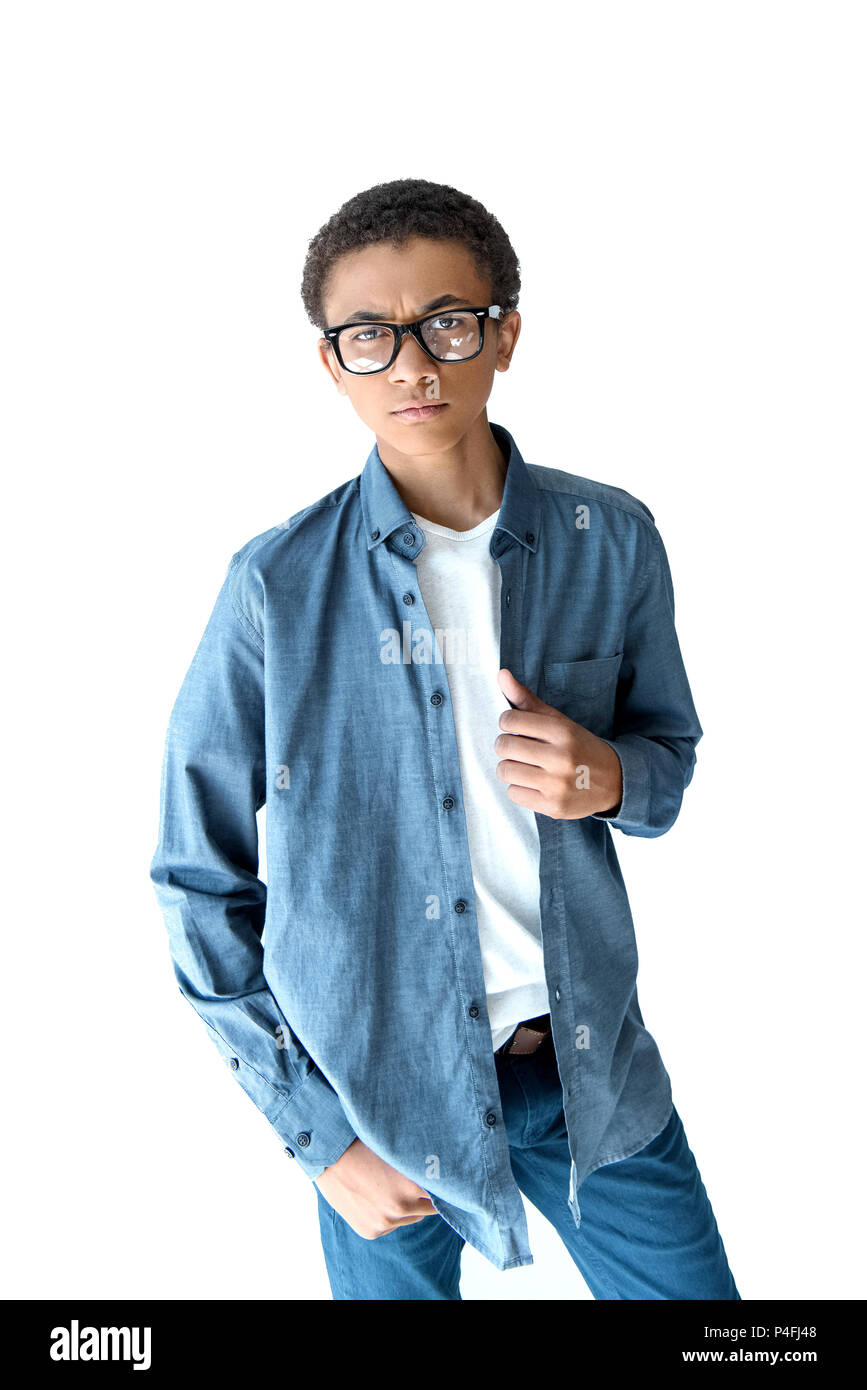 serious african american teenage boy in eyeglasses looking at camera ...
