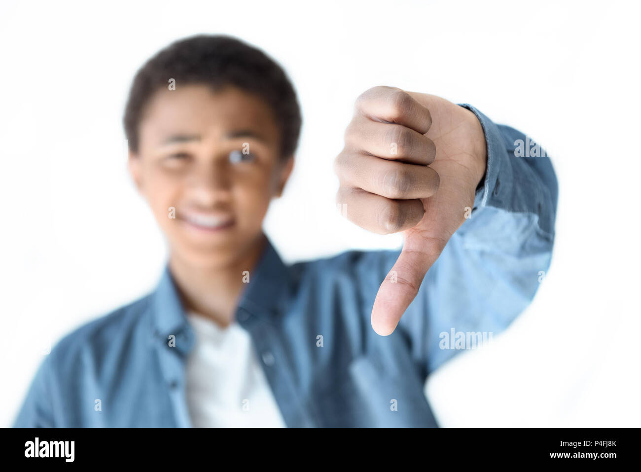 selective focus of african american teenager showing thumb down ...