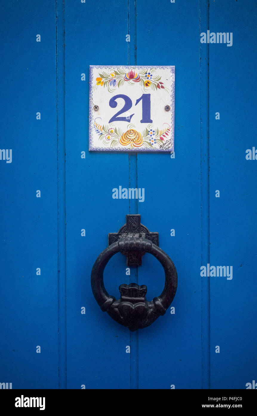 Blue doors with 21 digit on plate and knocker Stock Photo - Alamy