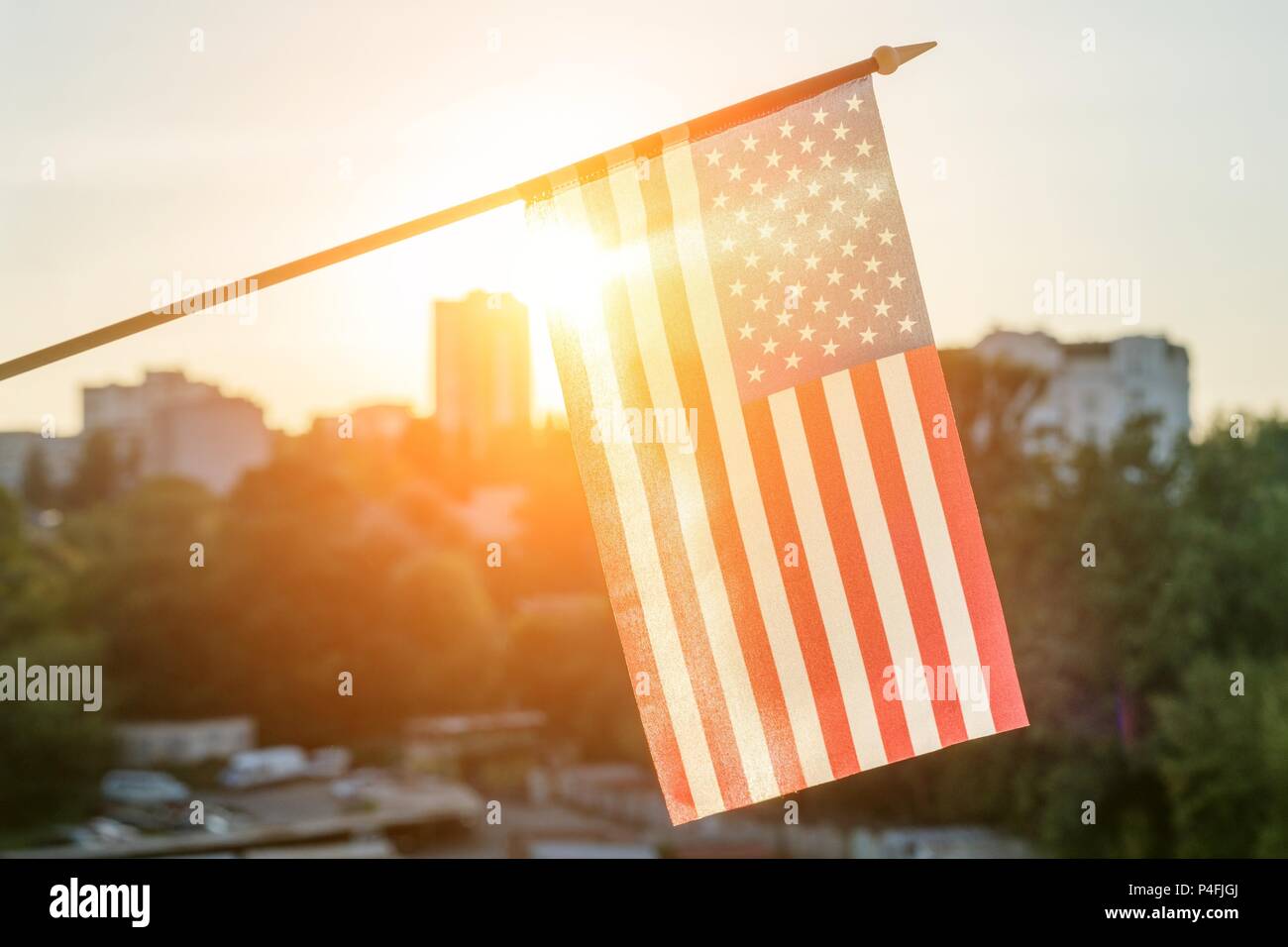 American flag from the window on sunset background Stock Photo - Alamy