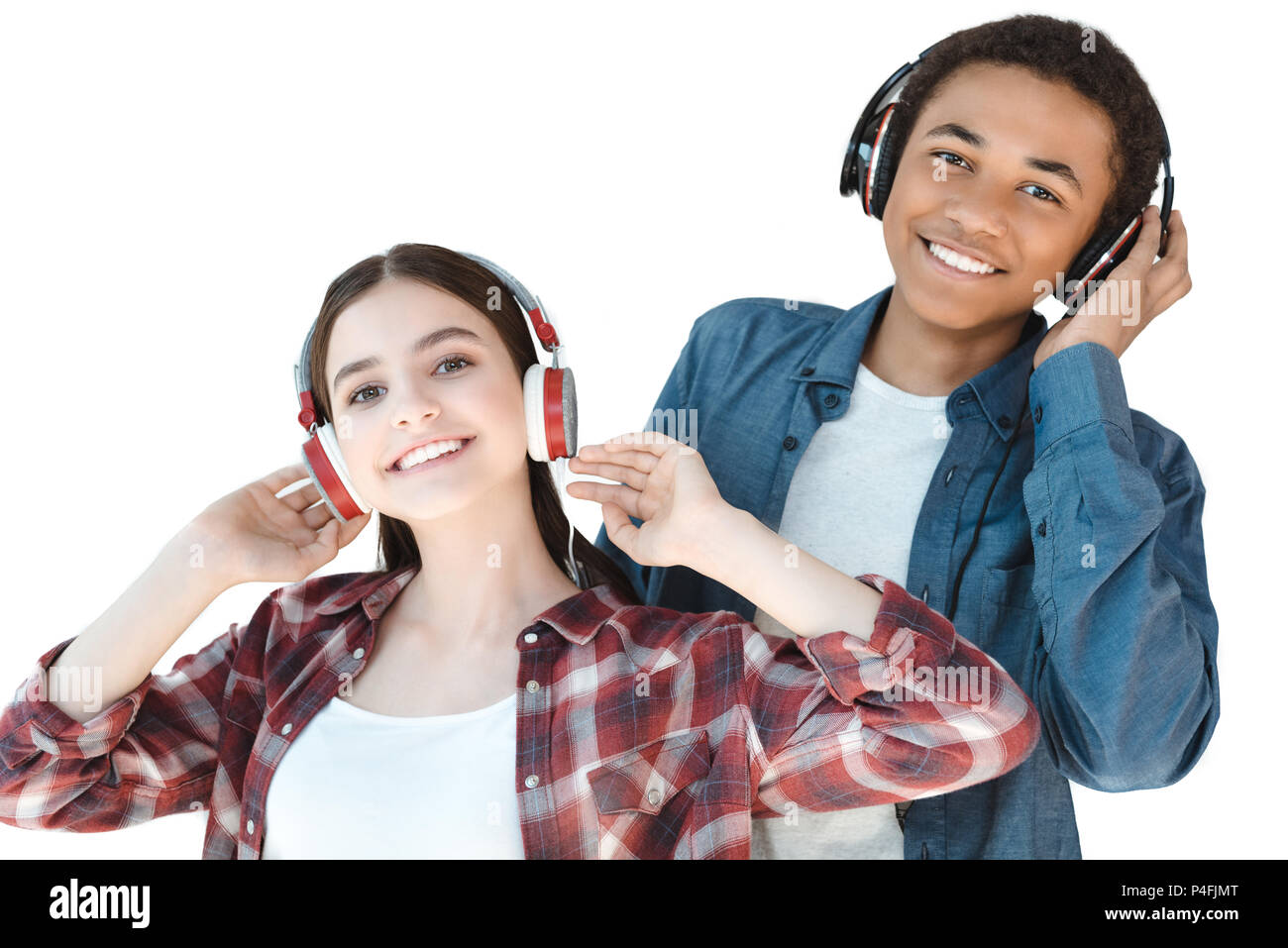 multiethnic teenagers looking at camera while listening music in ...