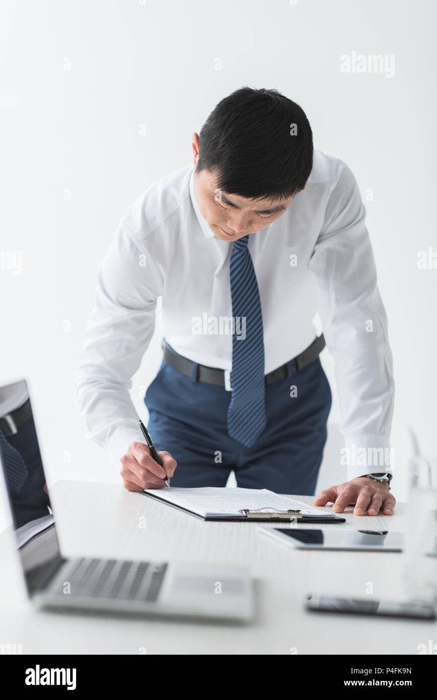 Attractive asian businessman sign document hi-res stock photography and ...