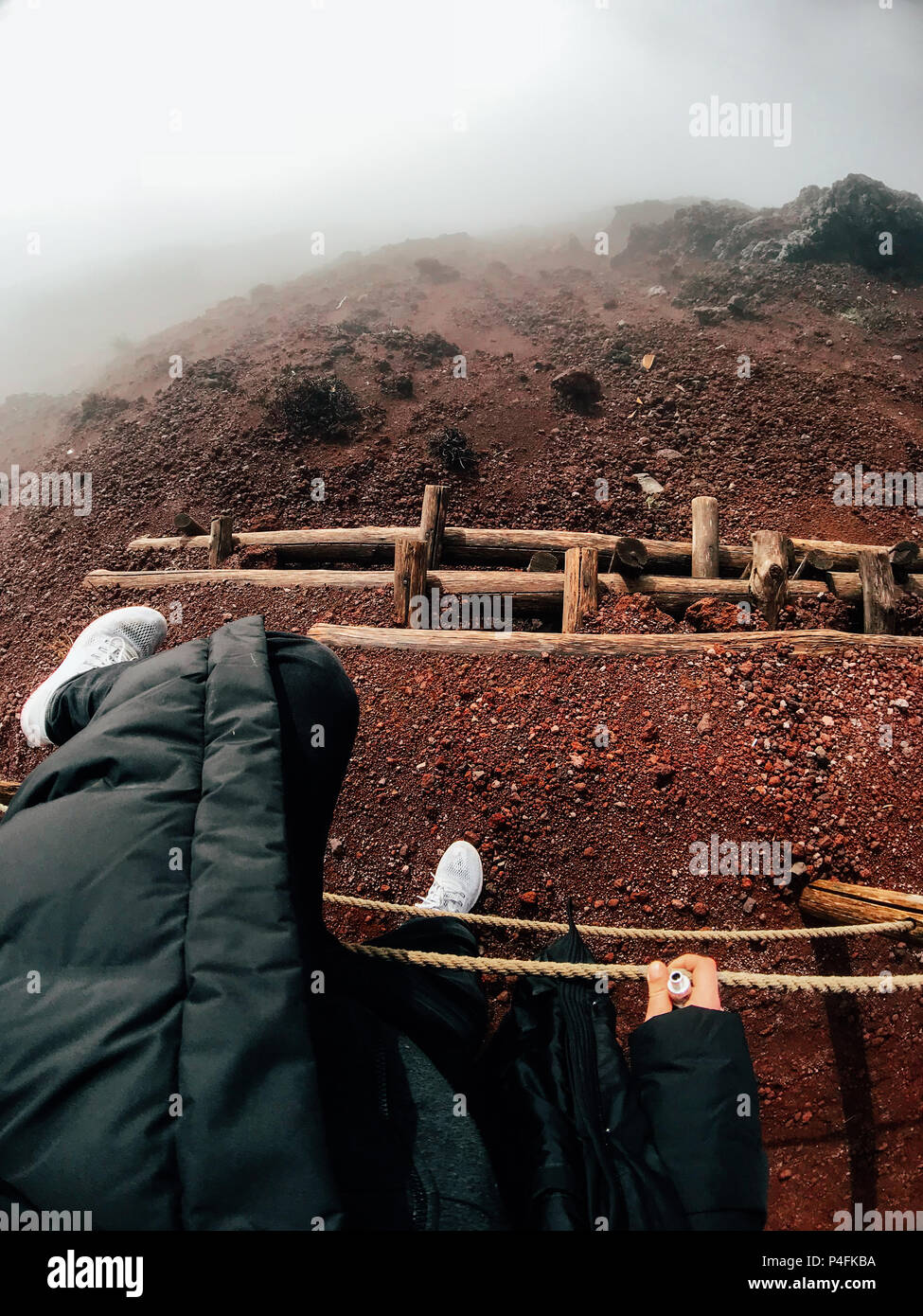 Man on cliff look at the fog Stock Photo - Alamy