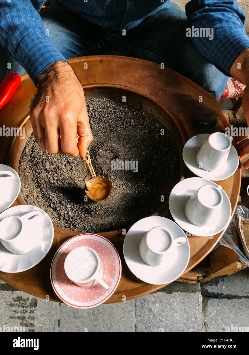 A man make Turkish coffee Stock Photo - Alamy
