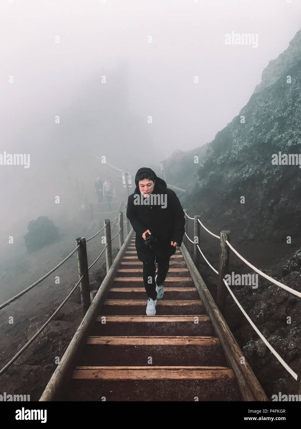 Man on the stairs railing Stock Photo - Alamy