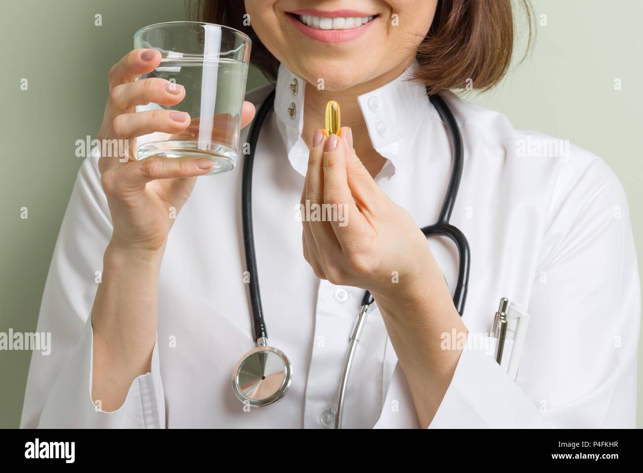 Female doctor takes vitamin capsule. Healthy lifestyle, nutritional ...