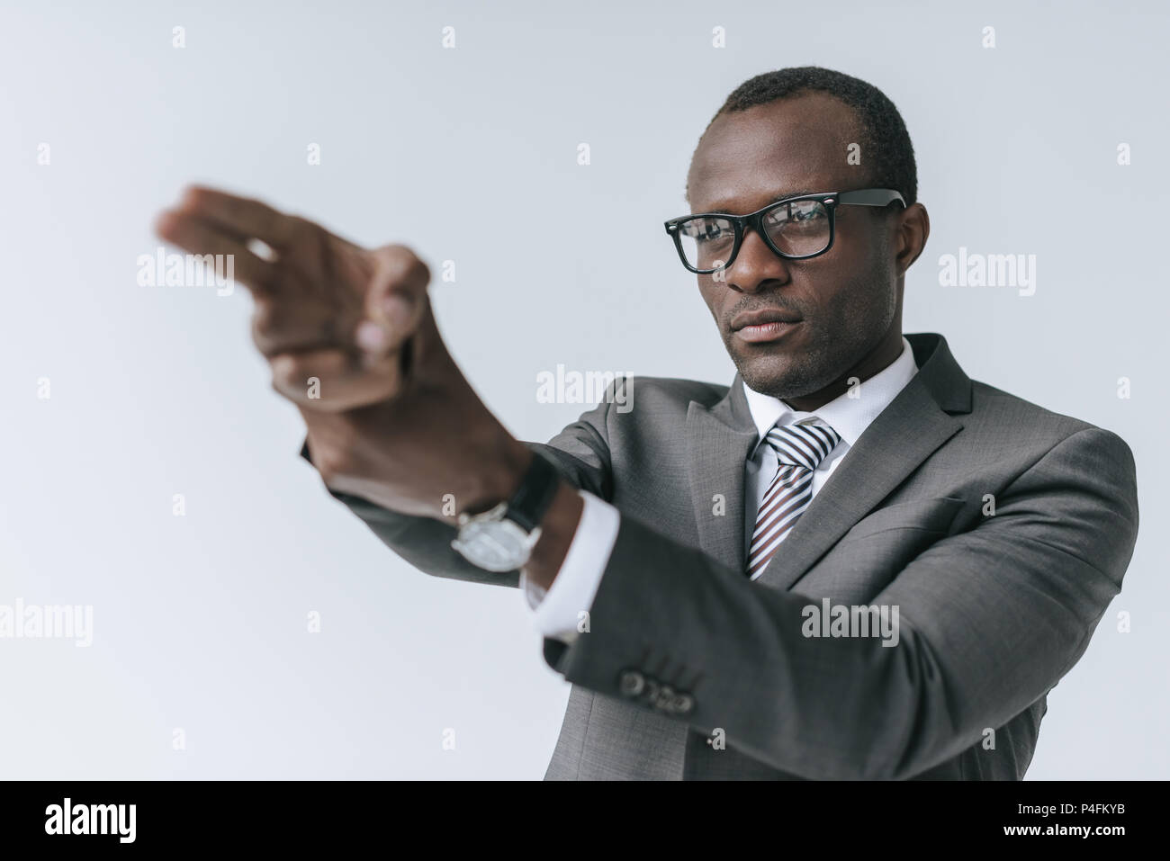 portrait of confident african american businessman showing gun sign ...