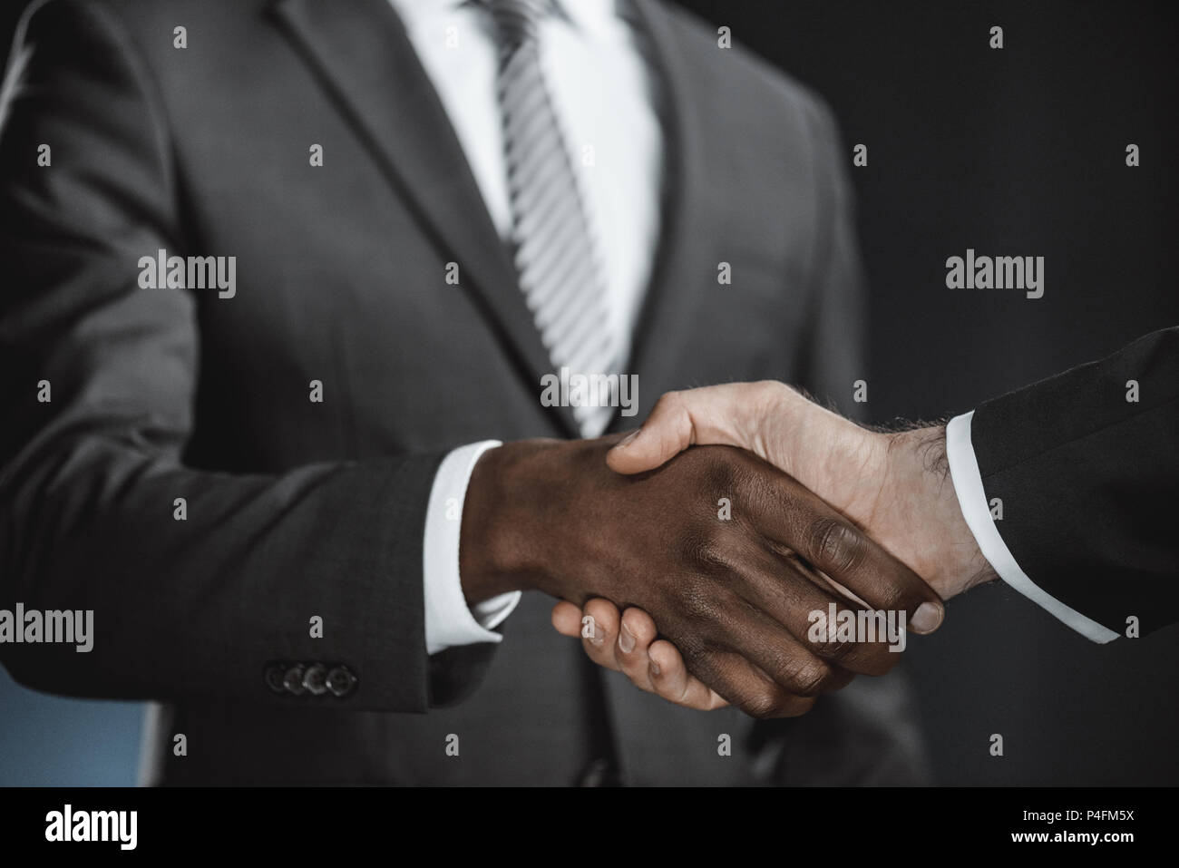 selective focus of multicultural businessmen handshake Stock Photo - Alamy