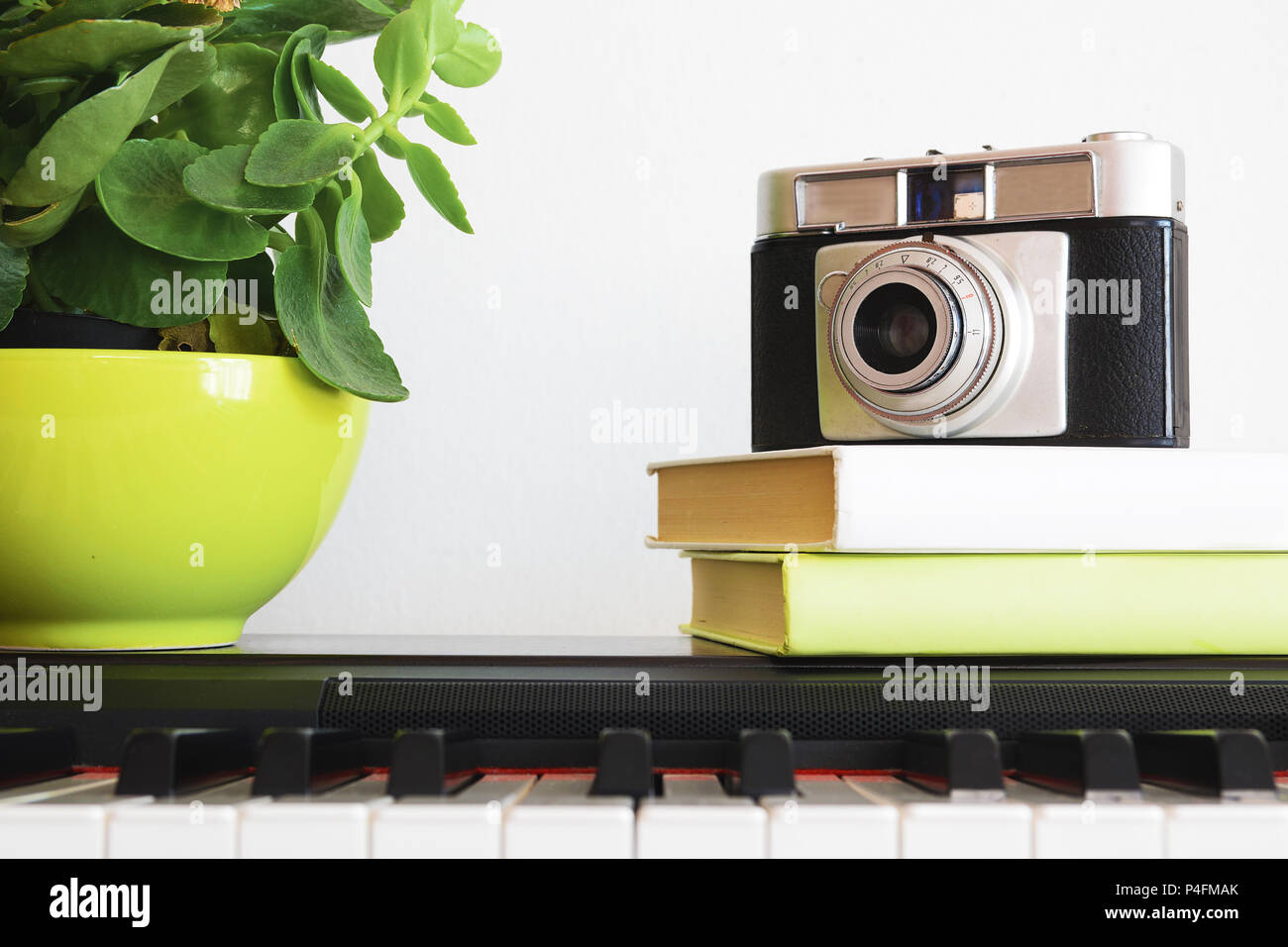 Vintage analogic camera on a piano in a living room. Empty copy space ...