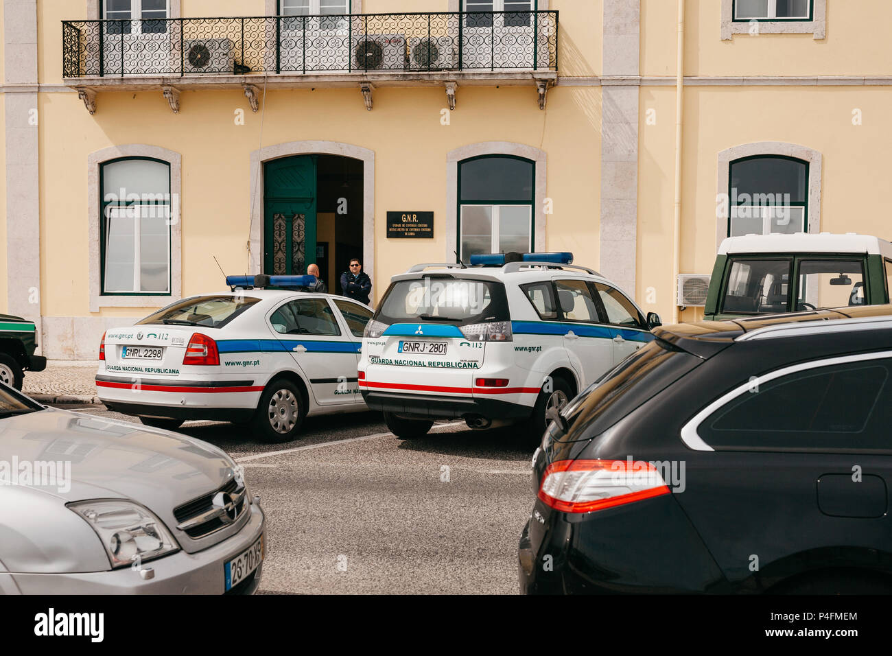 Lisbon, June 18, 2018: Patrol policemen and police cars are at the ...