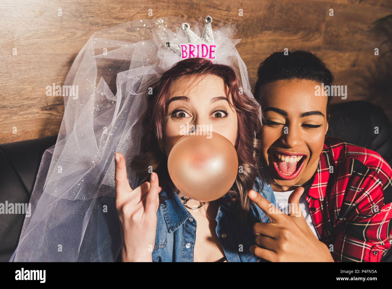 fiance blowing bubble gum and showing rock sign with happy african ...