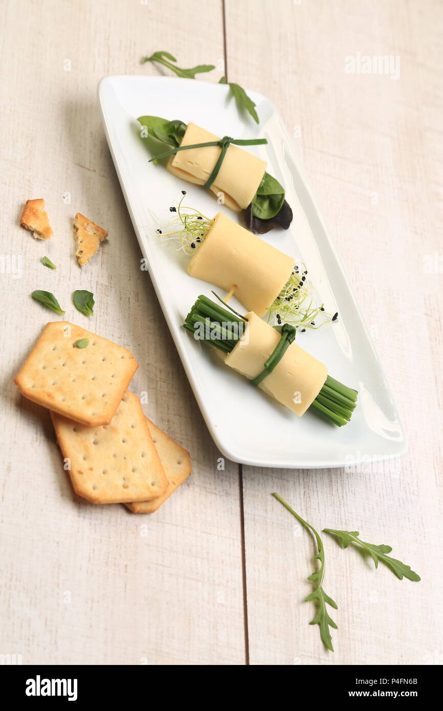 Cheese slices with green spices surrounded by the cheese Stock Photo ...