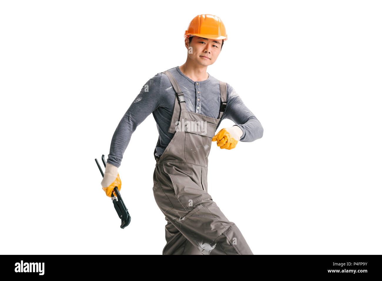 walking asian construction worker with pipe wrench isolated on white ...