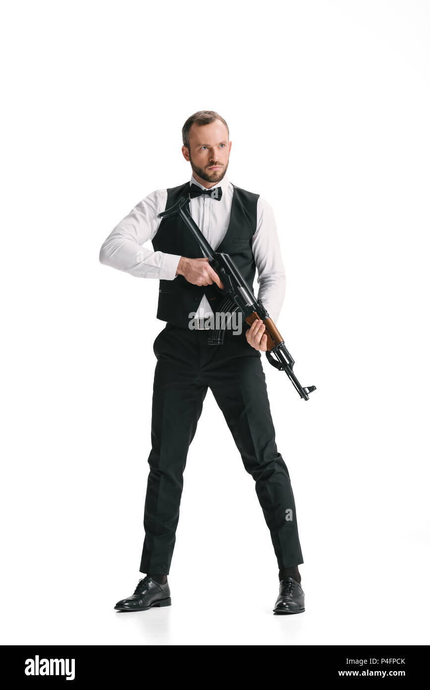 serious secret agent in suit with rifle isolated on white Stock Photo ...